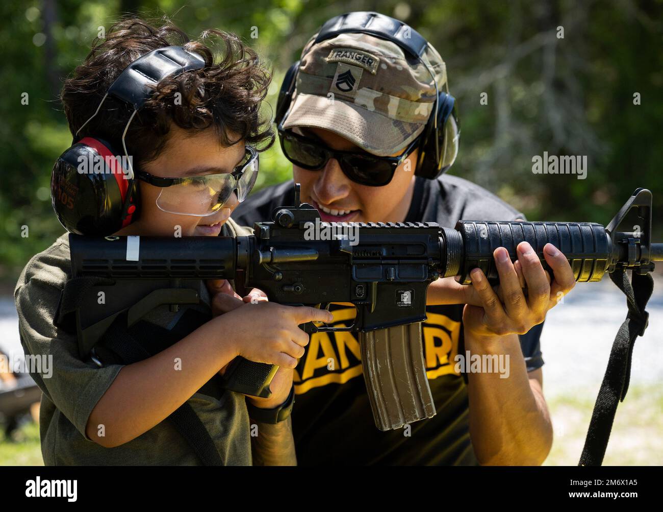 Staff Sgt. Geovany Lucero, 6th Ranger Training Battalion, helps a young ...
