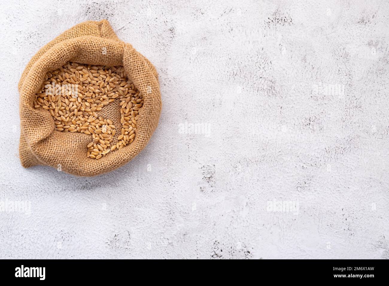 Wheat ears and wheat grains set up on white stone background Stock ...