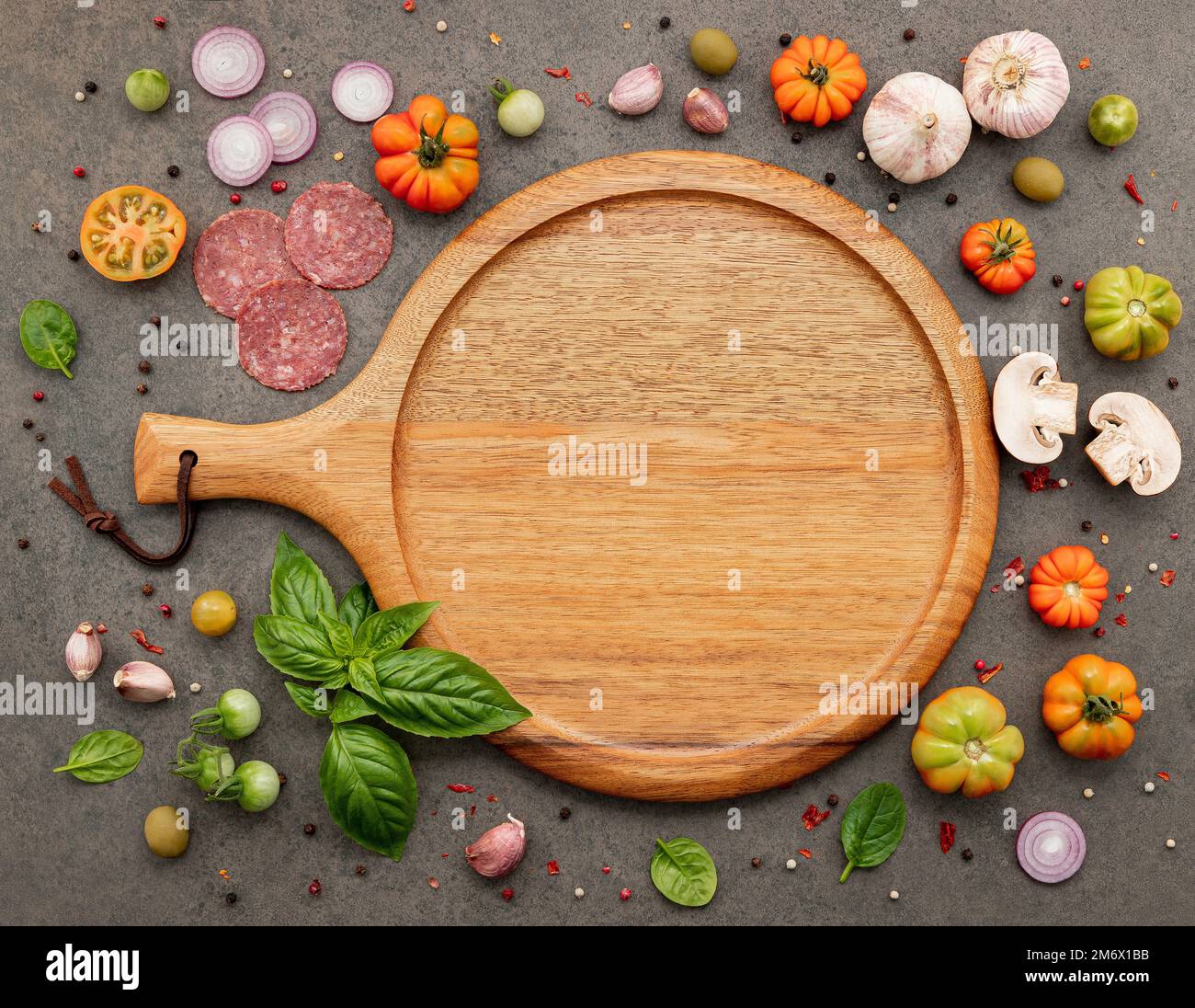 The ingredients for homemade pizza set up on dark stone background ...