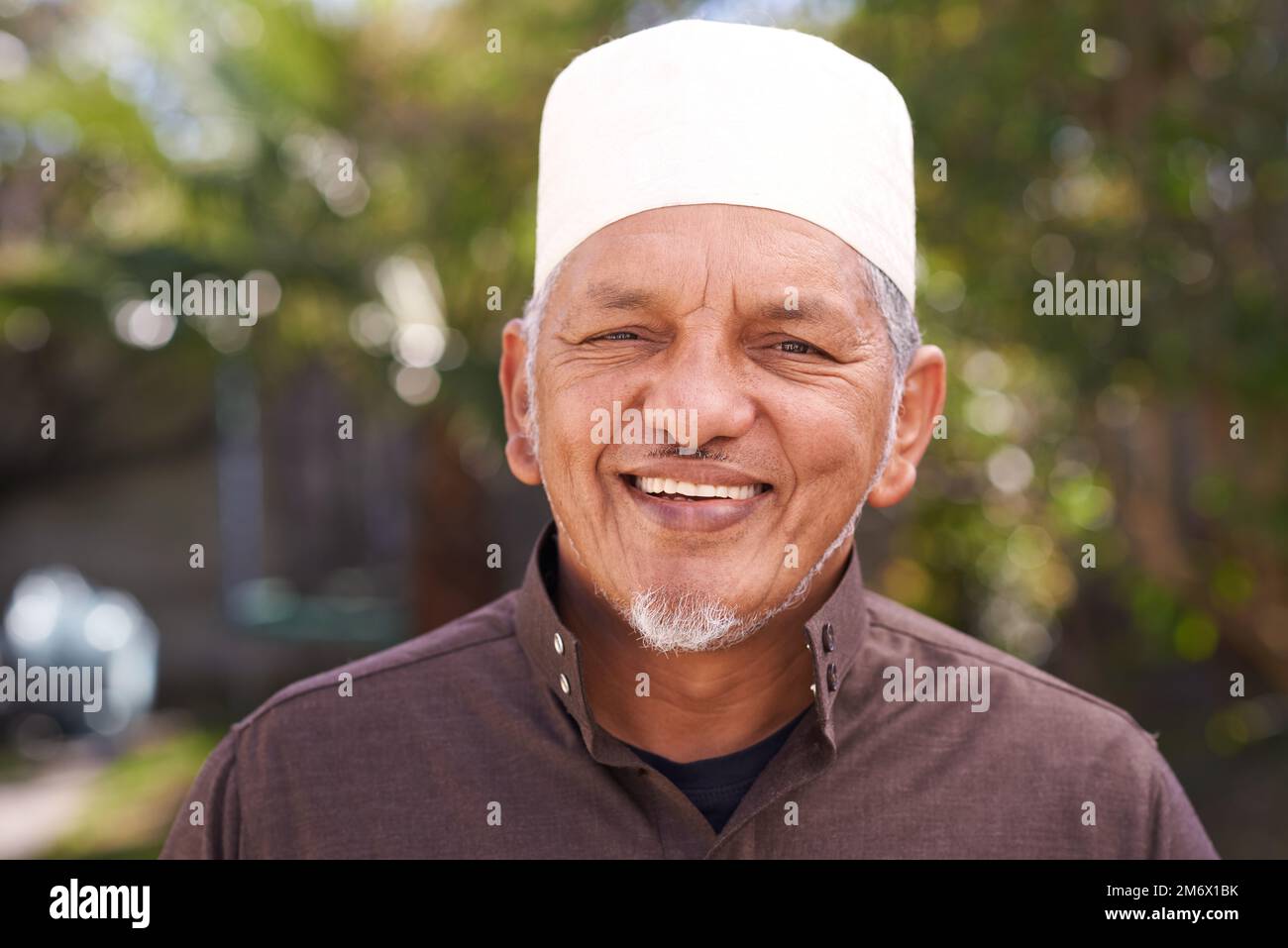 Living a happy life. Portrait of a mature muslim man standing outside ...