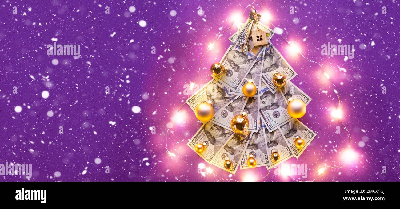 Christmas tree made of 100 dollar bills on purple background with ...