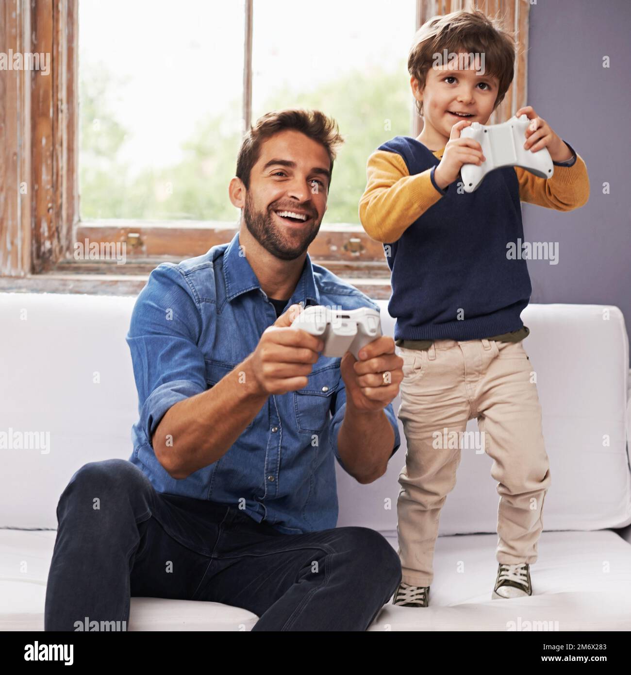 Showing Dad how its done. A handsome father and his cute son playing a ...