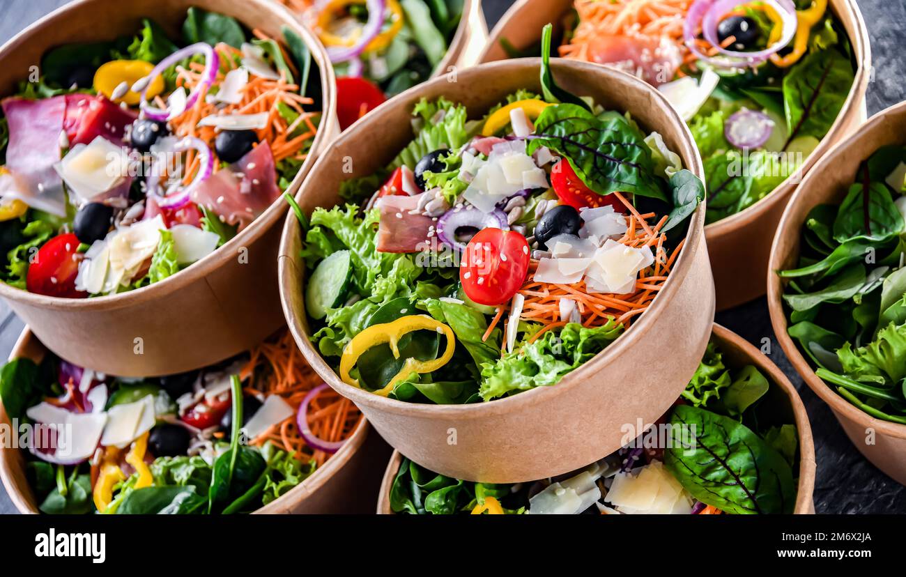 Round paper boxes with pre-packaged vegetable salads ready for sale ...