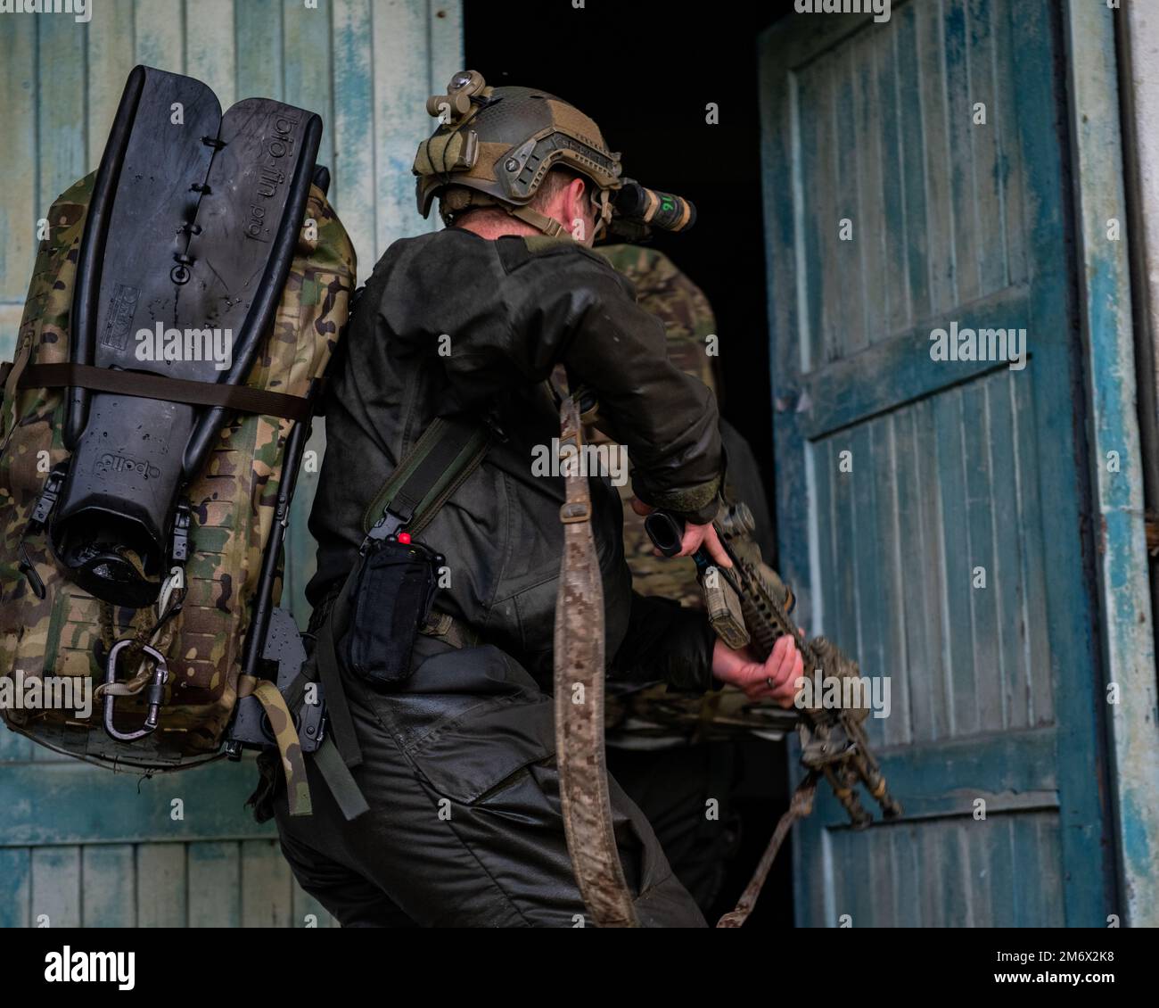 U.S. Navy SEALs conduct room clearance movements in a simulated urban ...