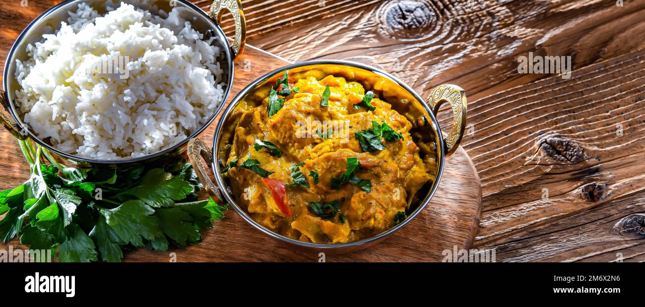 Curry chicken with rice served in original indian karahi pots Stock ...
