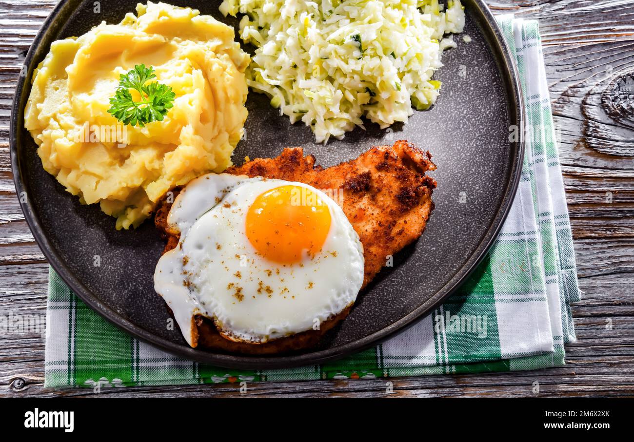 Breaded chicken cutlet served with fried chicken egg Stock Photo - Alamy Breaded chicken cutlet served with fried chicken egg Stock Photo - Alamy