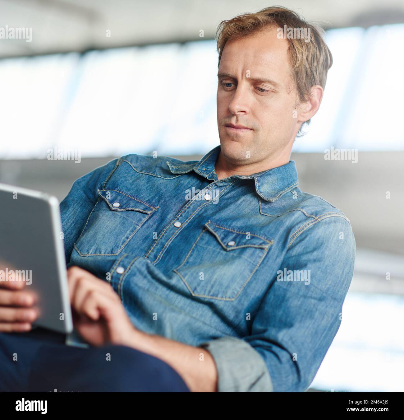 Beta testing the new mobi site. a handsome young man using a digital ...