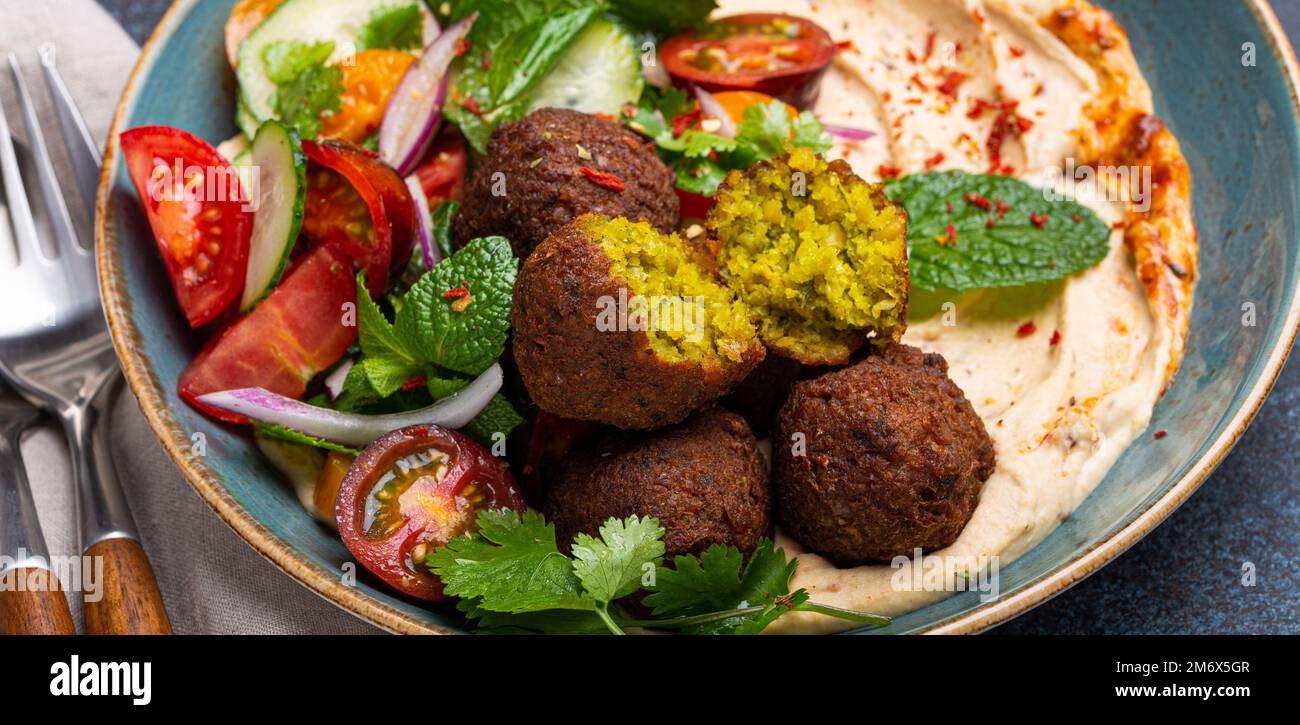 Close up of Middle Eastern Arab meal with fried falafel, hummus ...