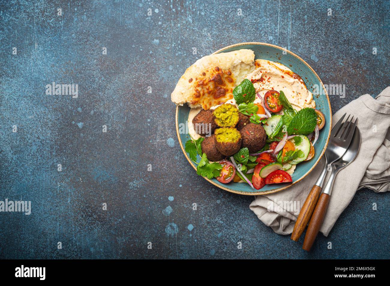 Middle Eastern Arab meal with fried falafel, hummus, vegetables salad ...
