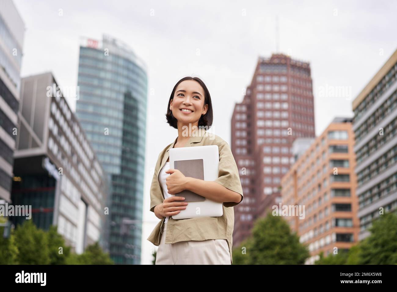 Portrait of young asian woman, looking happy and confident, going to ...