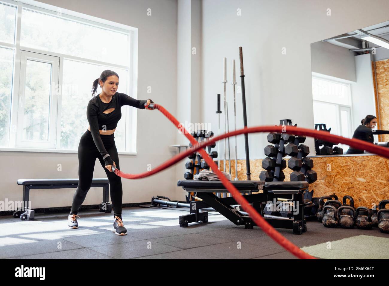 Attractive young slim and fit sportswoman working out in the gym for ...
