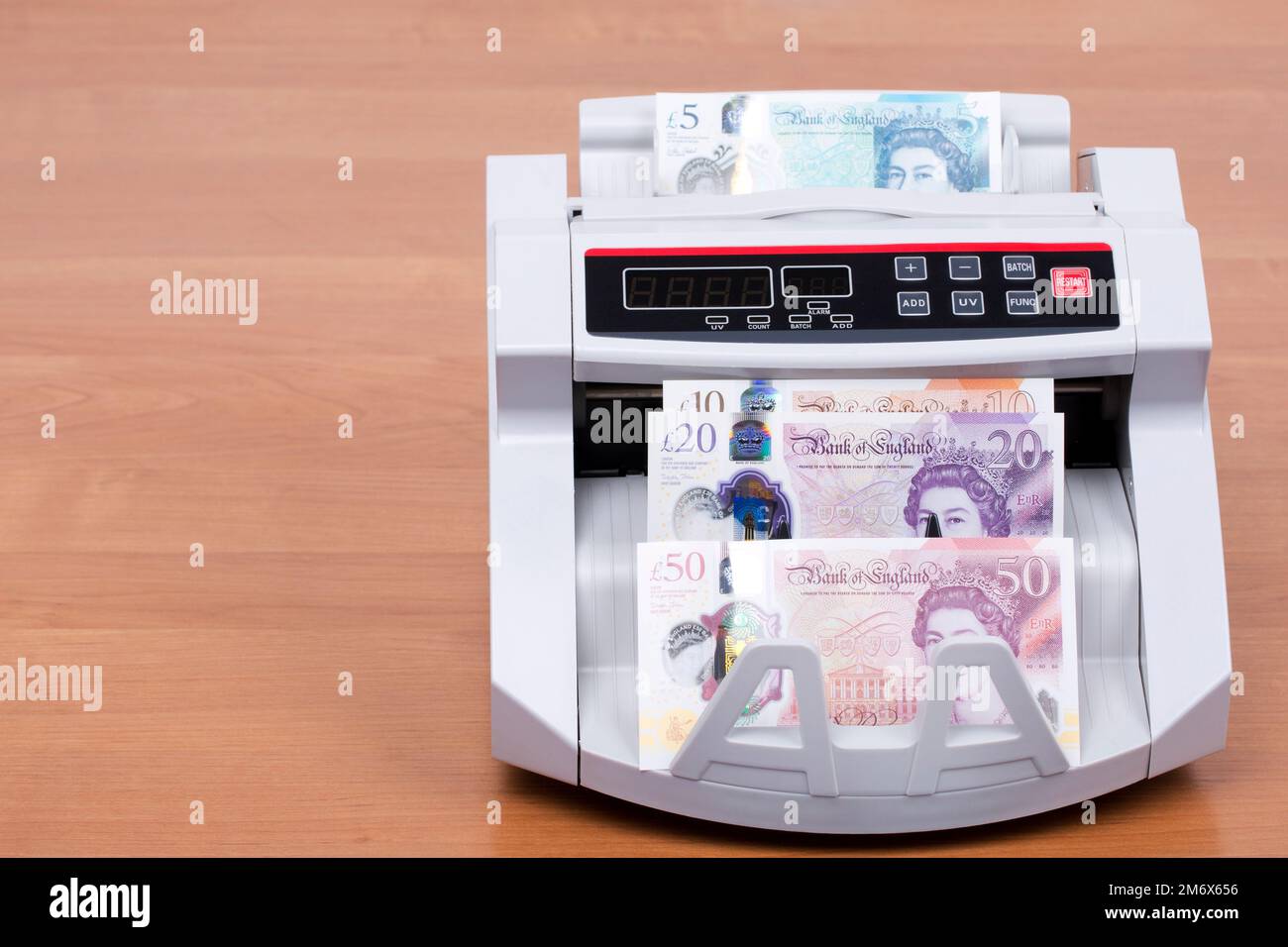 English Pounds in a counting machine Stock Photo - Alamy