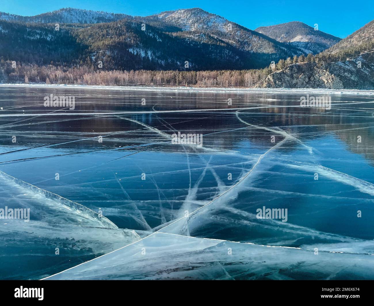 Texture of beautiful blue ice with cracks and air bubbles in the frozen ...