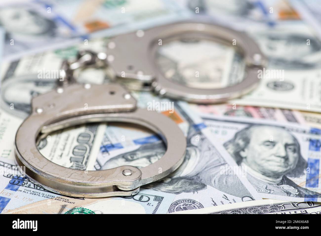 Handcuffs on money background. Dollar bills, money cash corruption ...