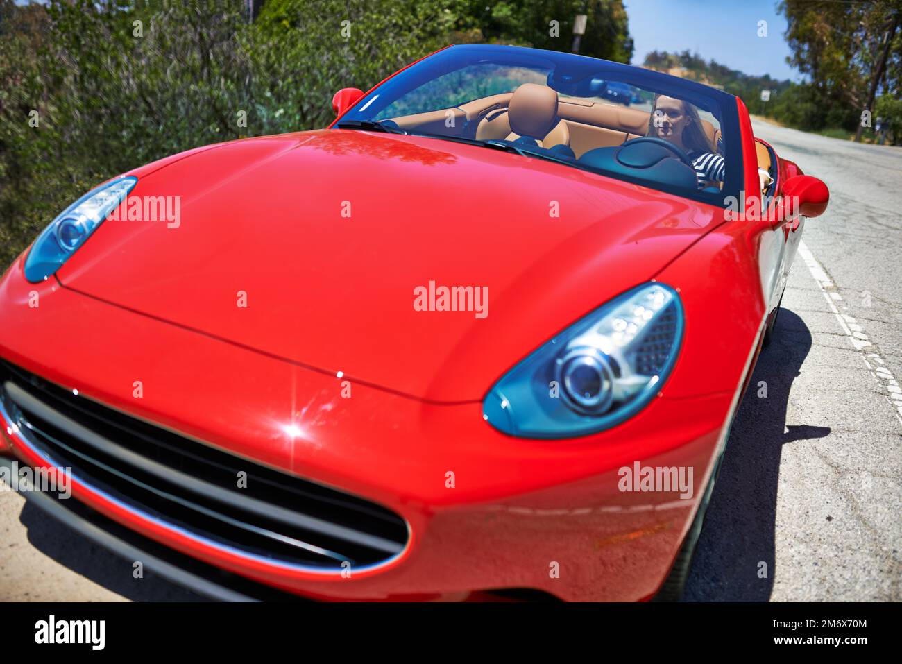 Shes a lean mean street machine. a young woman driving in a sports car ...