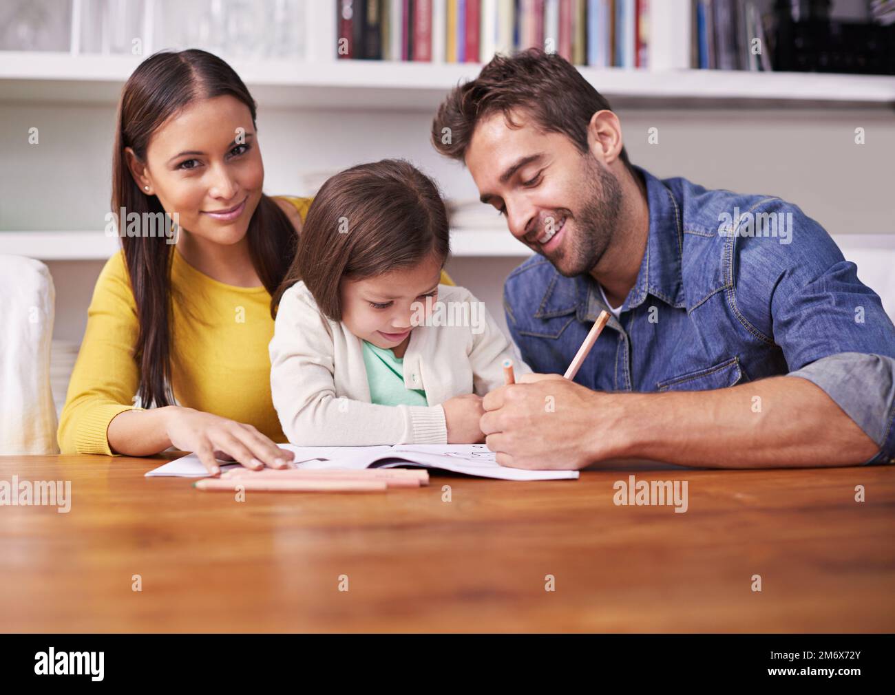 Creativity is intelligence having fun. a young family doing art work ...