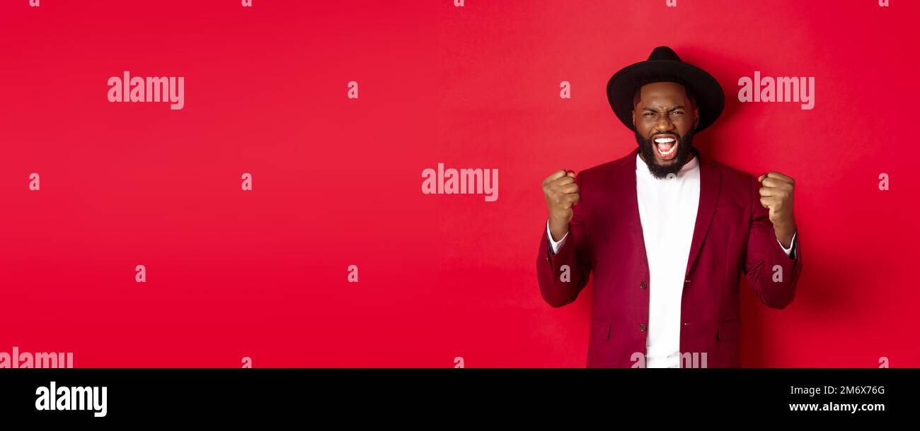 Satisfied lucky Black man celebrating victory, screaming from rejoice ...