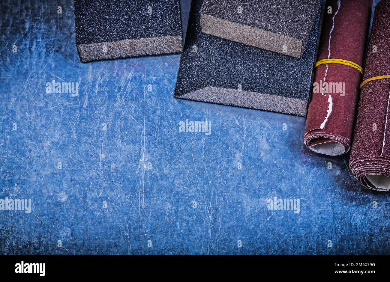 Abrasive sponges paper on scratched metallic background construction ...