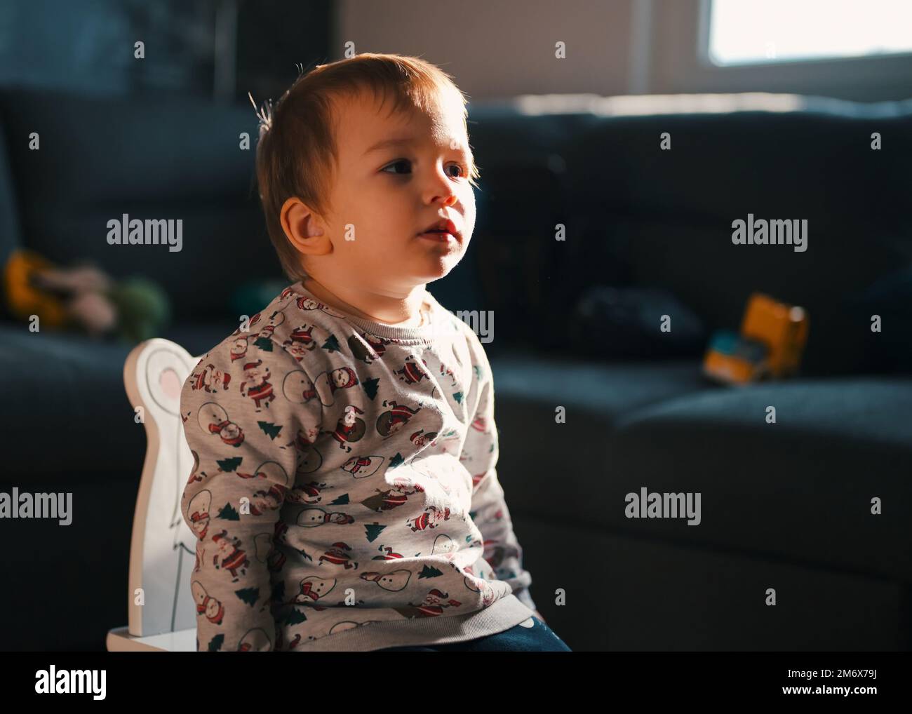 Little toddler sitting in living room and watching television Stock ...