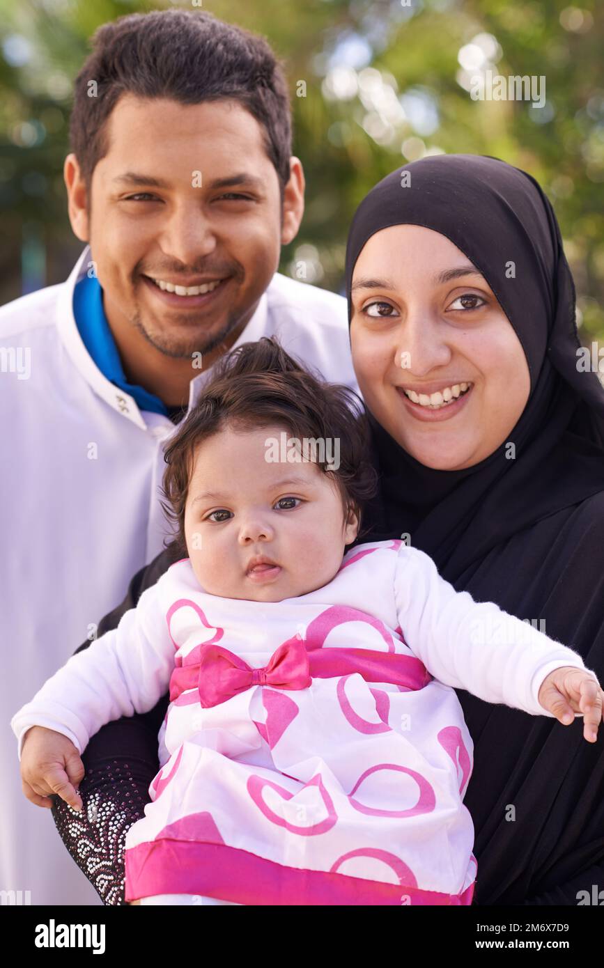 Shes a laughing little bundle of joy. Portrait of a muslim family ...