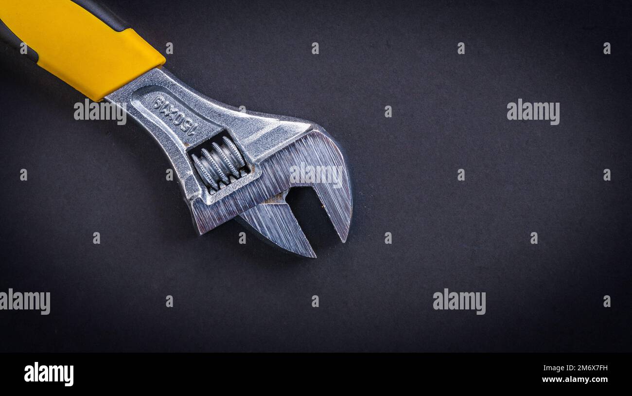 adjustable wrench with yellow handle Stock Photo - Alamy