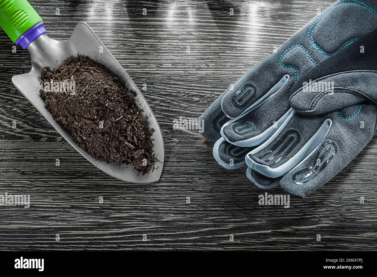 Agriculture hand spade soil safety gloves on wooden board Stock Photo ...