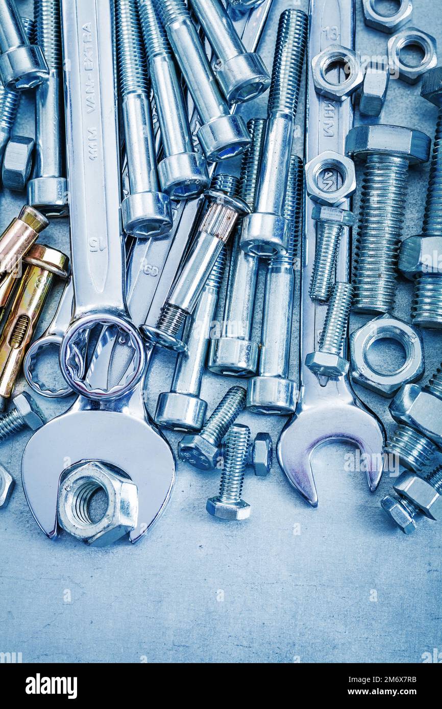 Anchor bolts screwbolts nuts hook wrenches and flat spanner on metallic ...