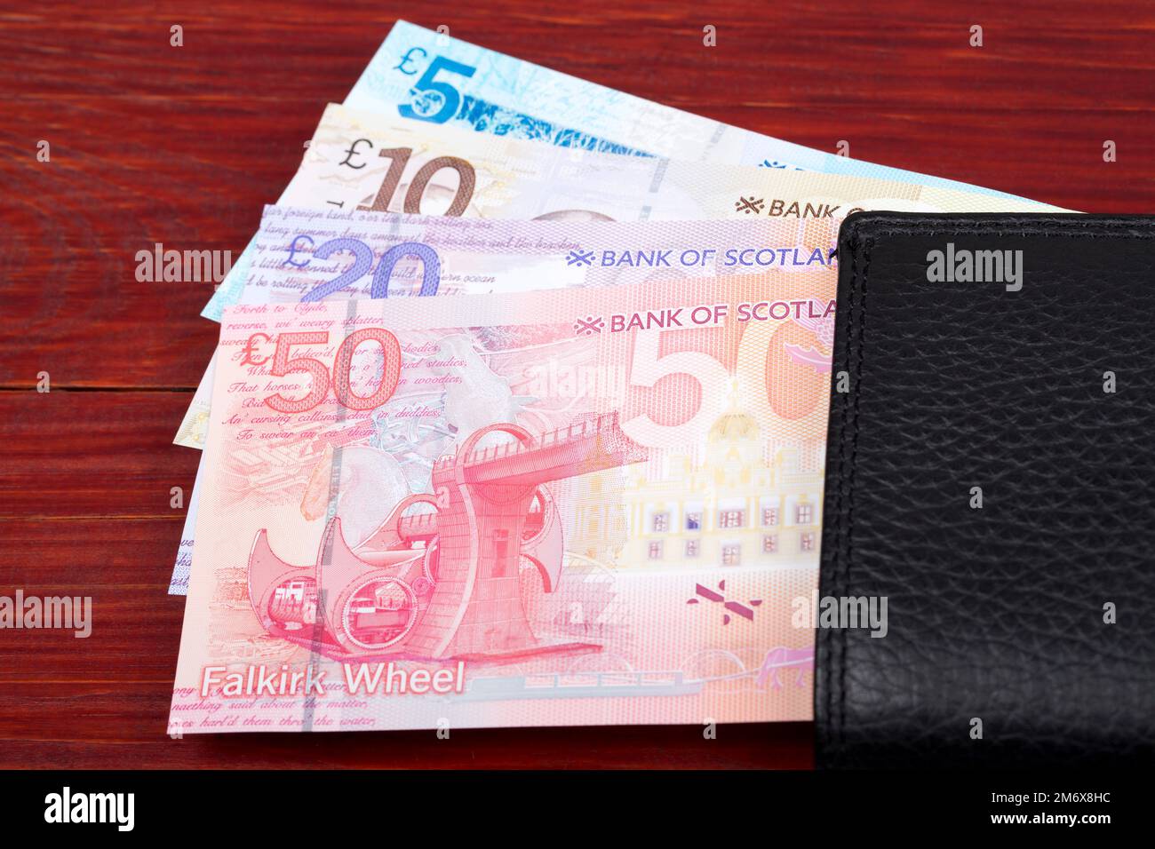 Pound Scots in the black wallet Stock Photo - Alamy