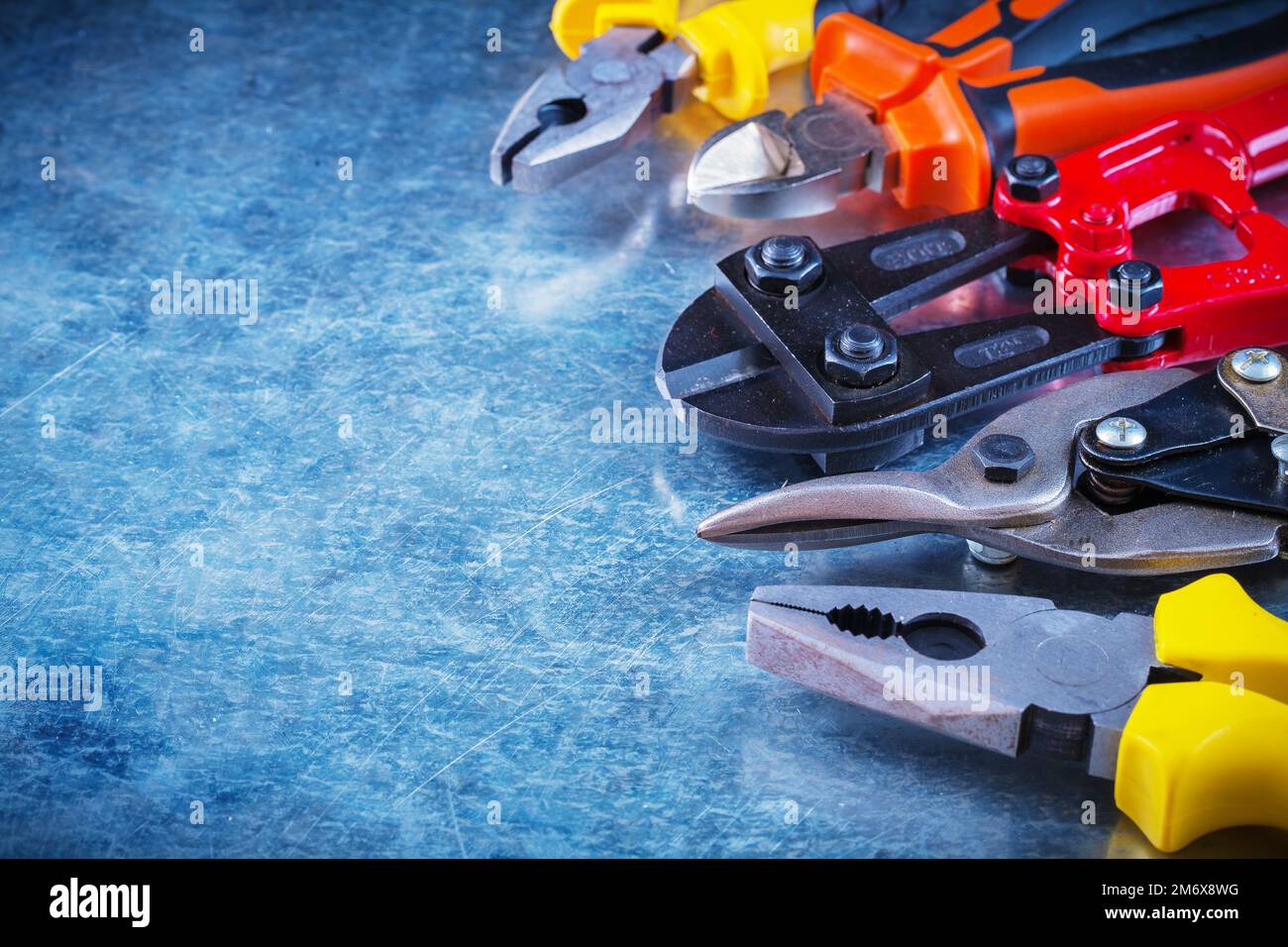 Bolt cutter tin snips cutting pliers gripping tongs on scratched ...