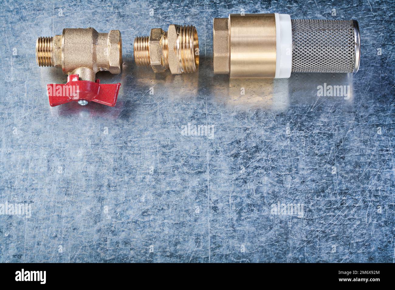 Brass water gate valve with strainer filter on metallic background ...