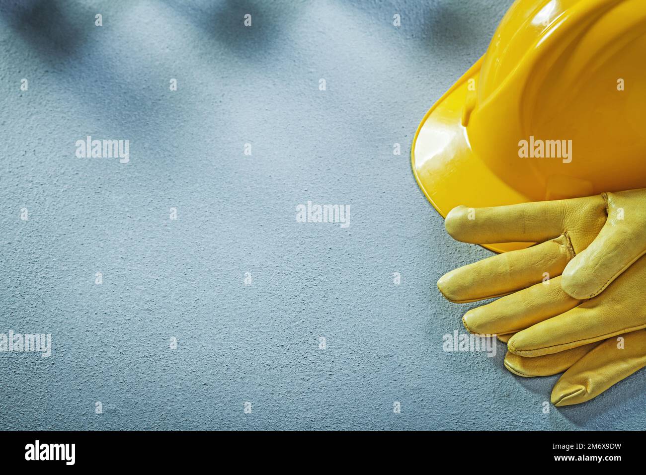 Building helmet safety gloves on concrete surface copy space ...