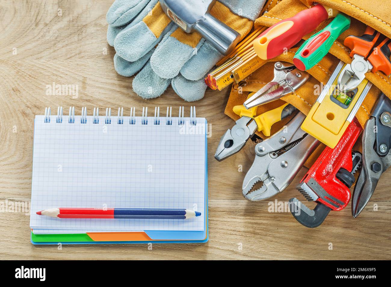 Building tooling tool belt safety gloves claw hammer notepad pencil ...