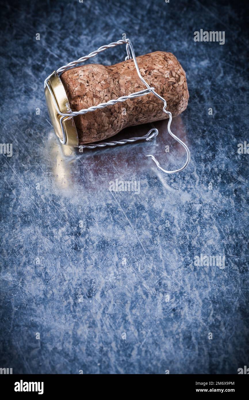 Champagne cork twisted wire on scratched metallic background copy space ...