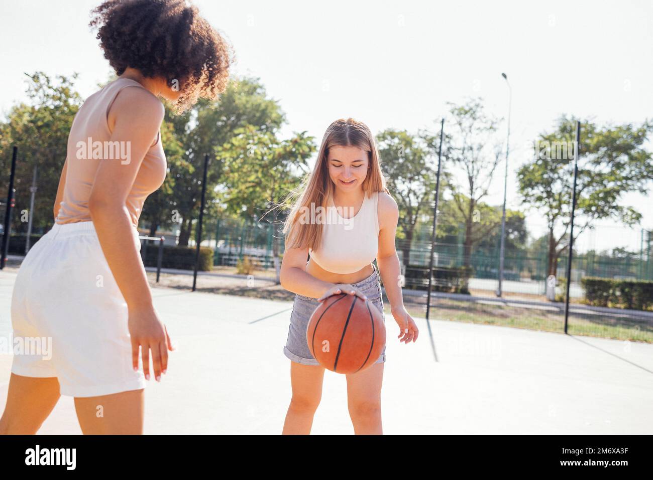 Teen girls playing basketball outdoors hi-res stock photography and ...