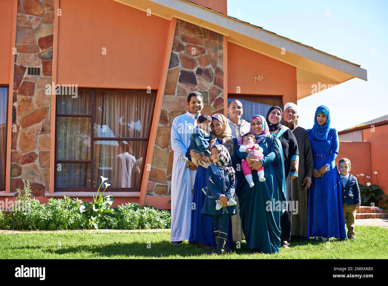 Were a family full of love. Portrait of a happy muslim family standing ...