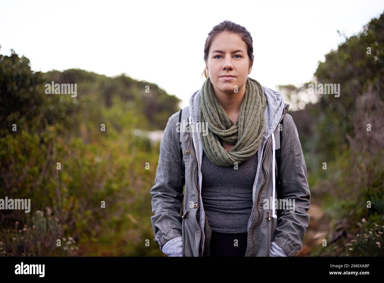Hiking in the mountains. Portrait of an attractive young female hiker ...