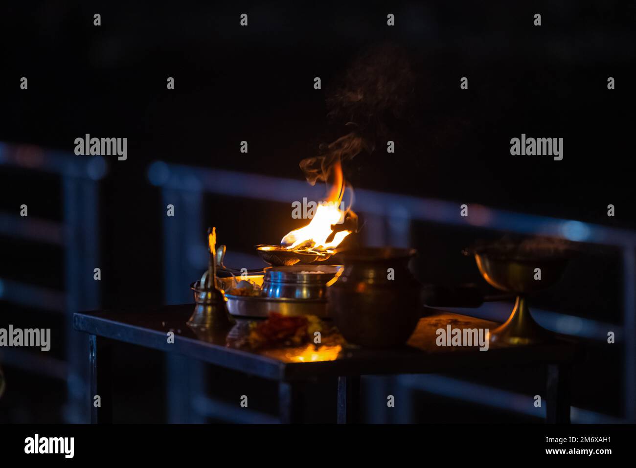 Fire flame at night with dark background during the ganga aarti rituals ...