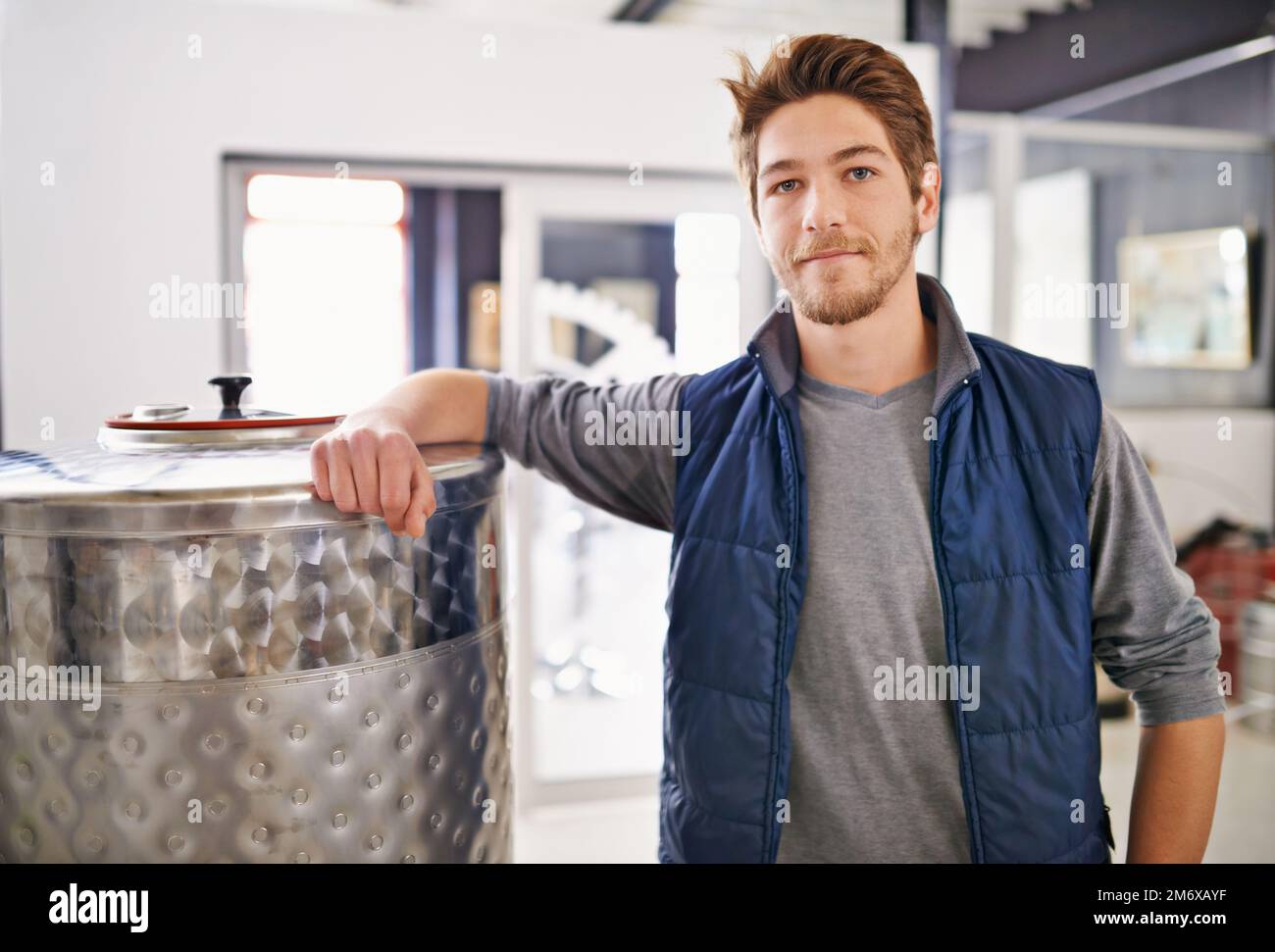 The newest brew is ready to go. Portrait of a man working in a ...