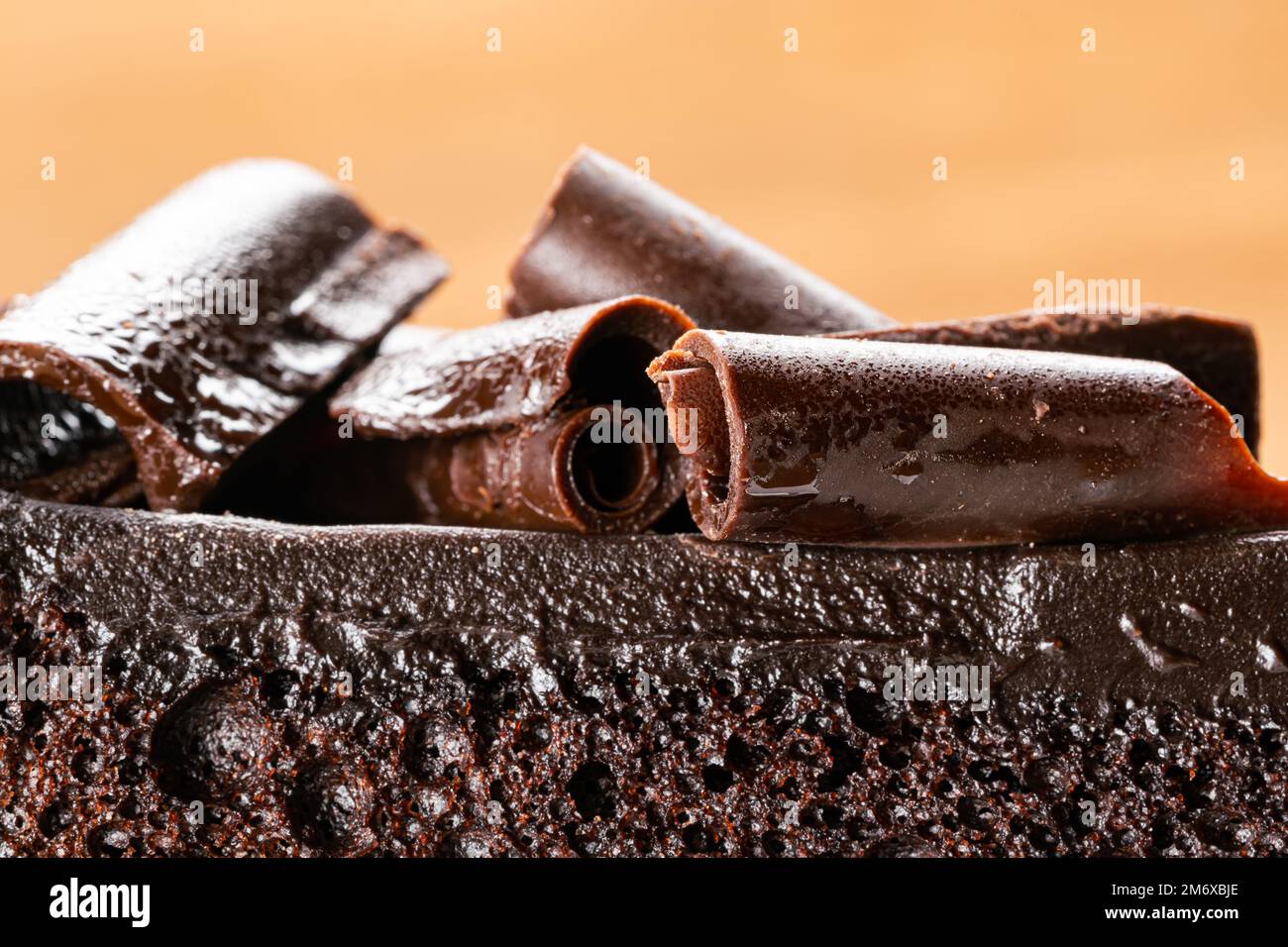 Chocolate sponge cake topping with chocolate tube Stock Photo - Alamy