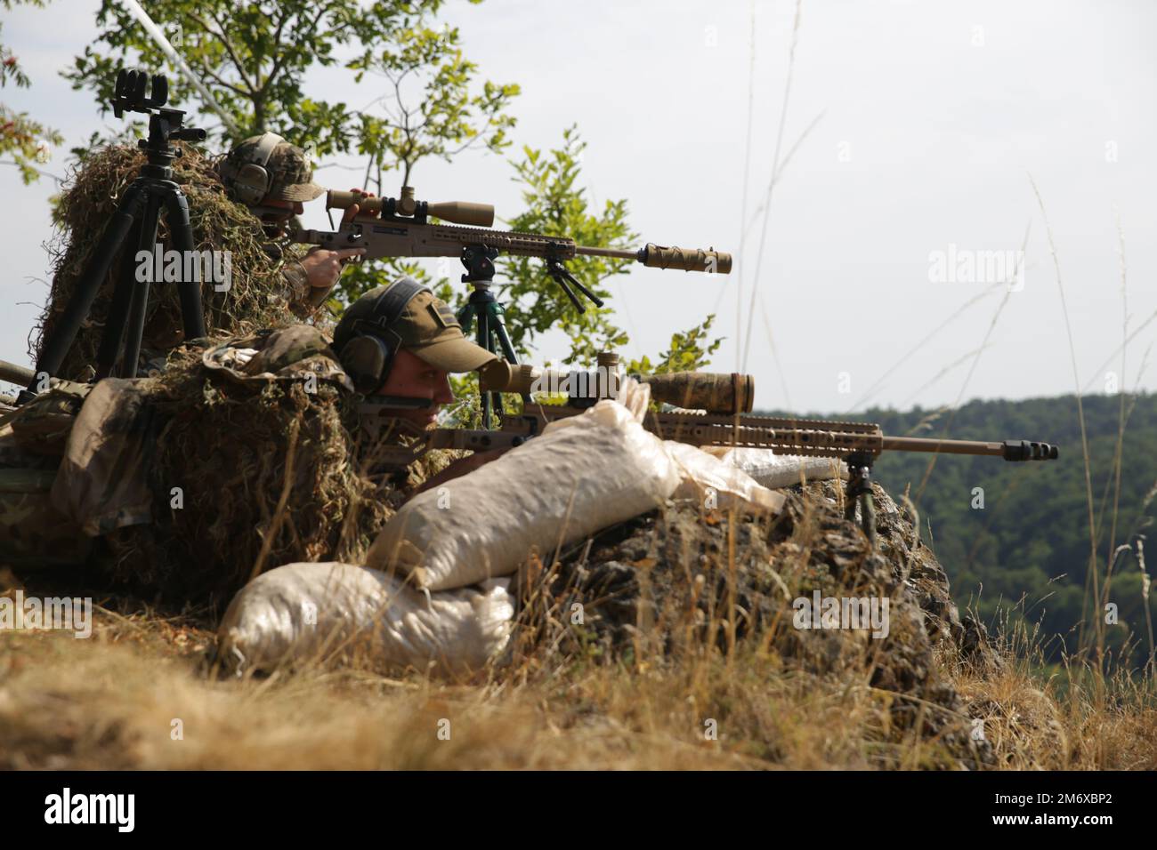 A sniper team looks through their weapon's sights during the European ...