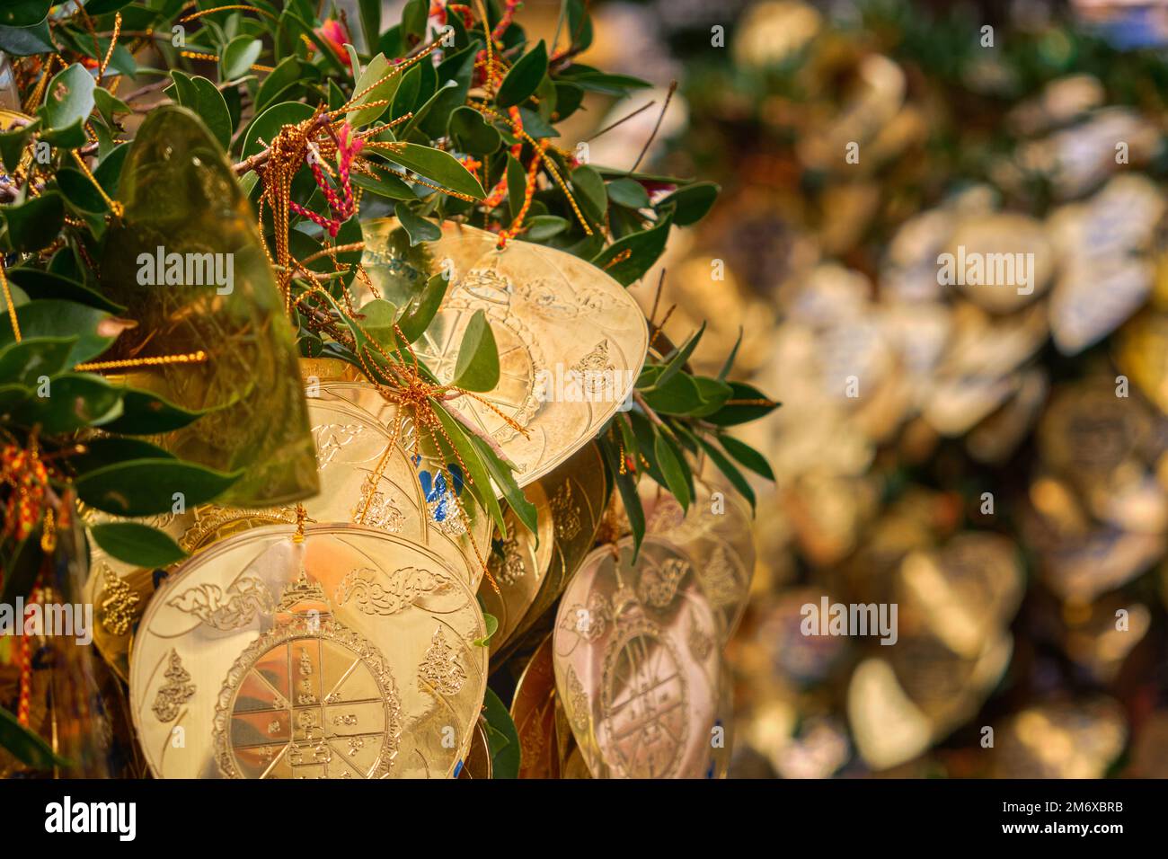 Thai buddhist golden leaves with wishes tied to Bodhi tree Stock Photo ...