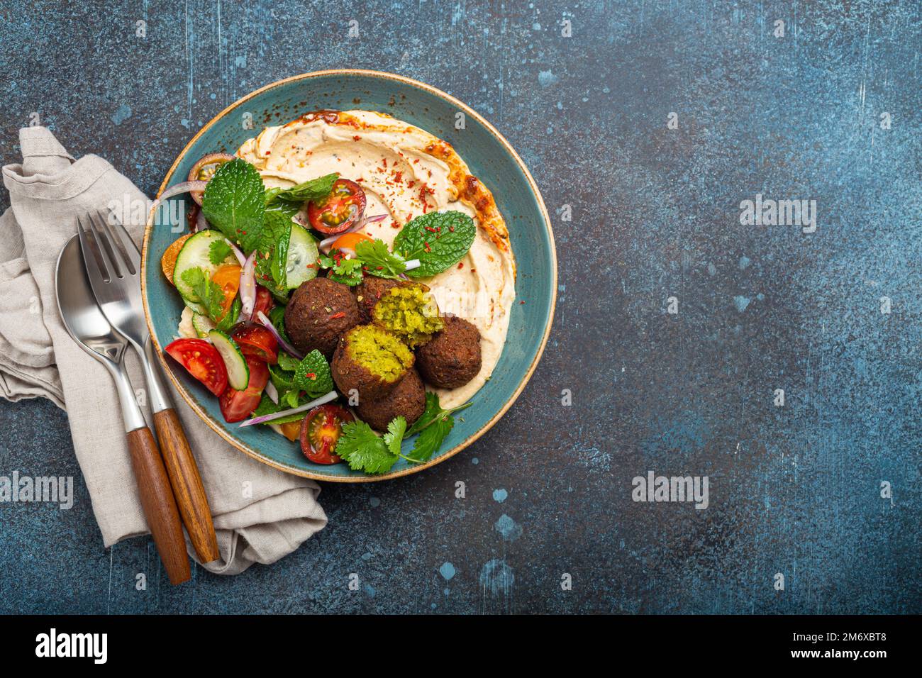 Middle Eastern Arab meal with fried falafel, hummus, vegetables salad ...