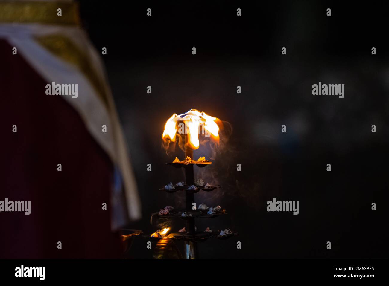 Fire flame at night with dark background during the ganga aarti rituals ...