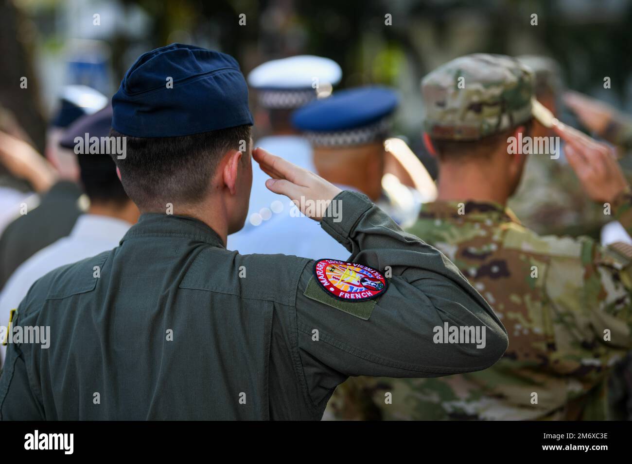 A U.S. Airmen salute as part of a multilateral formation during a ...