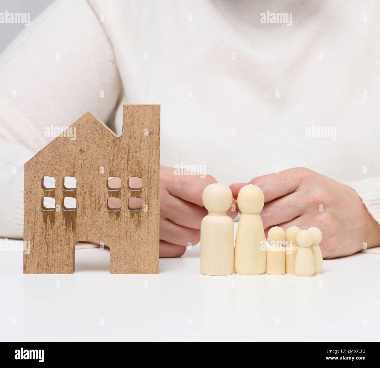 Wooden house and figures of a family. Real estate insurance concept ...
