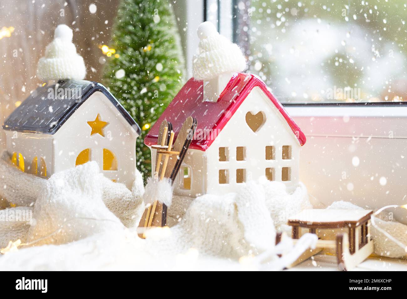 Cozy house is wrapped in a hat and scarf in a snowstorm -window sill ...