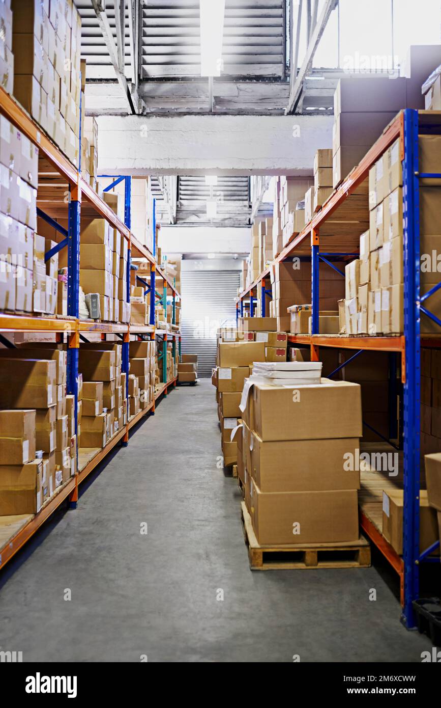 Everything under one roof. Large warehouse storage shelves with boxes ...