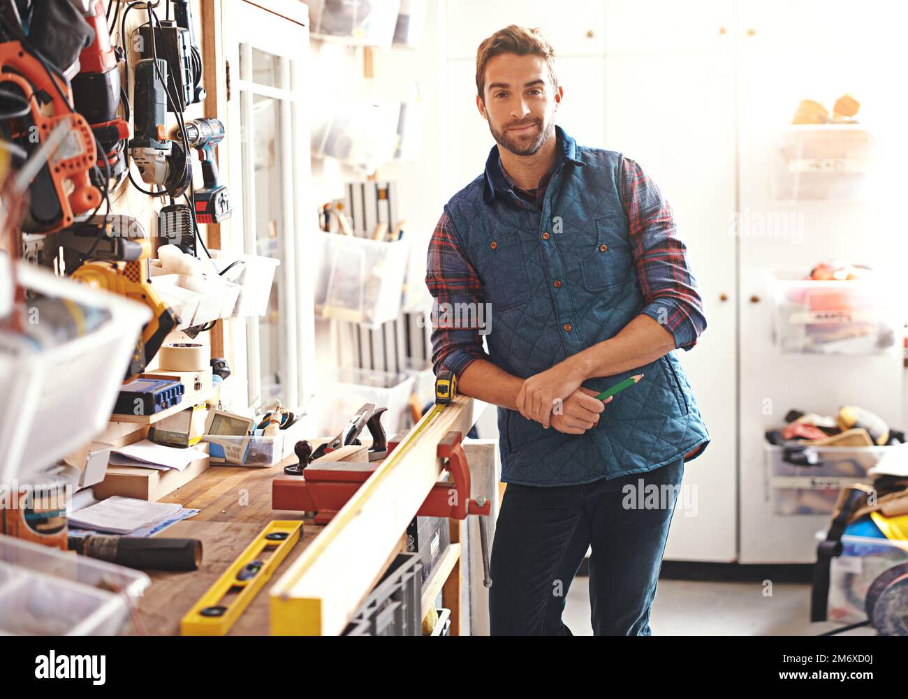 I have a tool for any job. Portrait of a man standing in his workshop ...