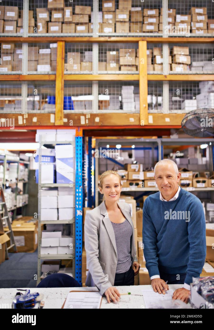 Getting the order sorted. managers at work supervising a shipping and ...