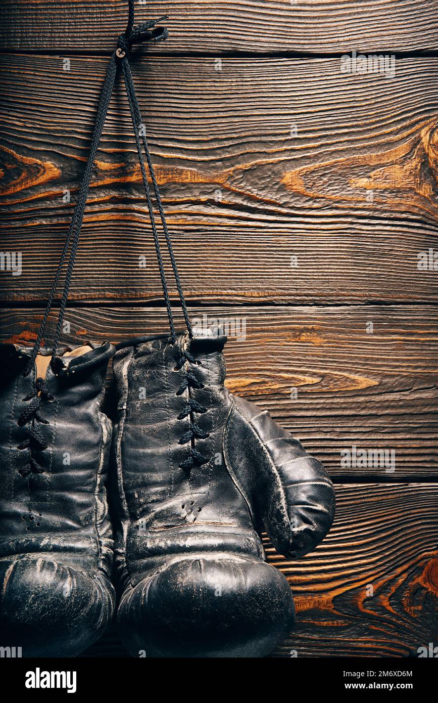 Old boxing gloves hanging on nail on wooden wall Stock Photo - Alamy